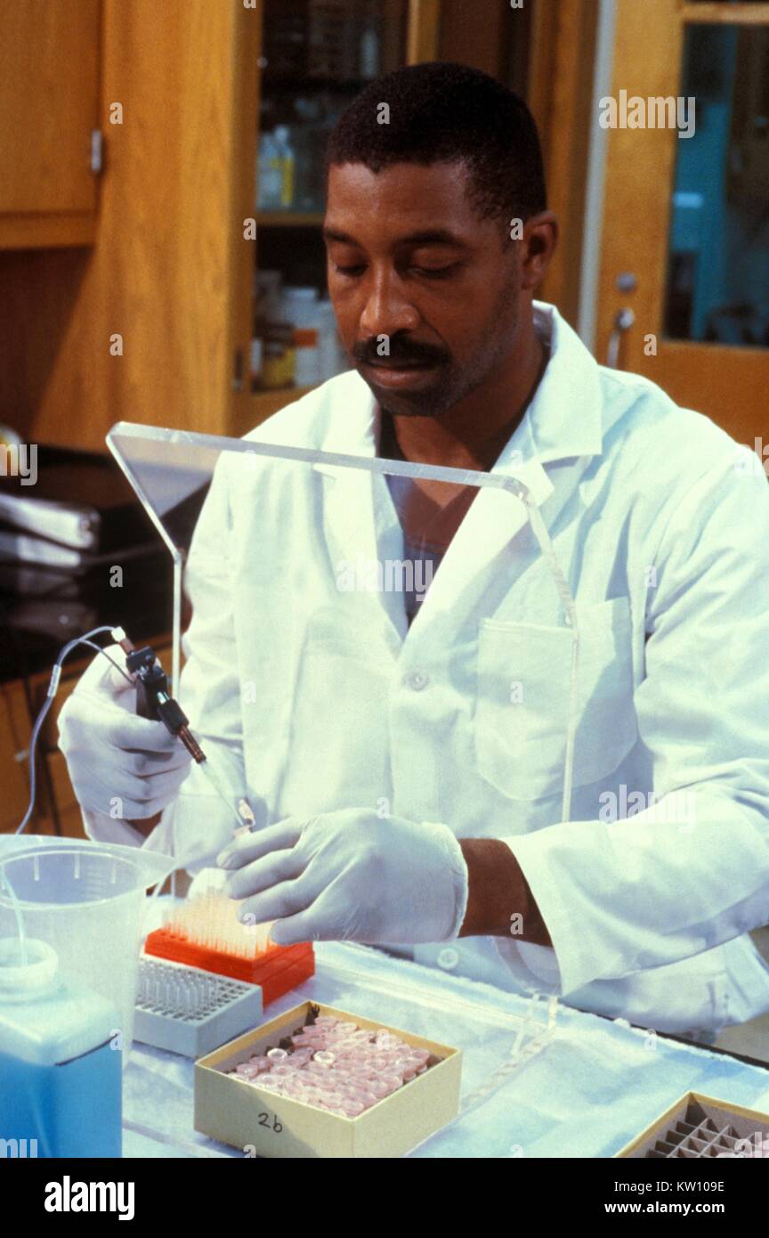 This CDC lab technician is working on AIDS research during a series of ...