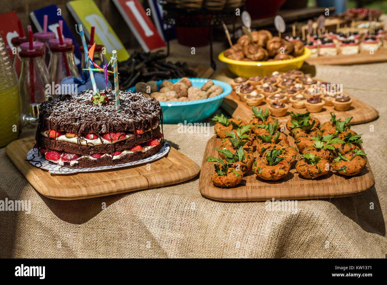 Cakes, canapes and other cookies on birthday party food service buffet ...
