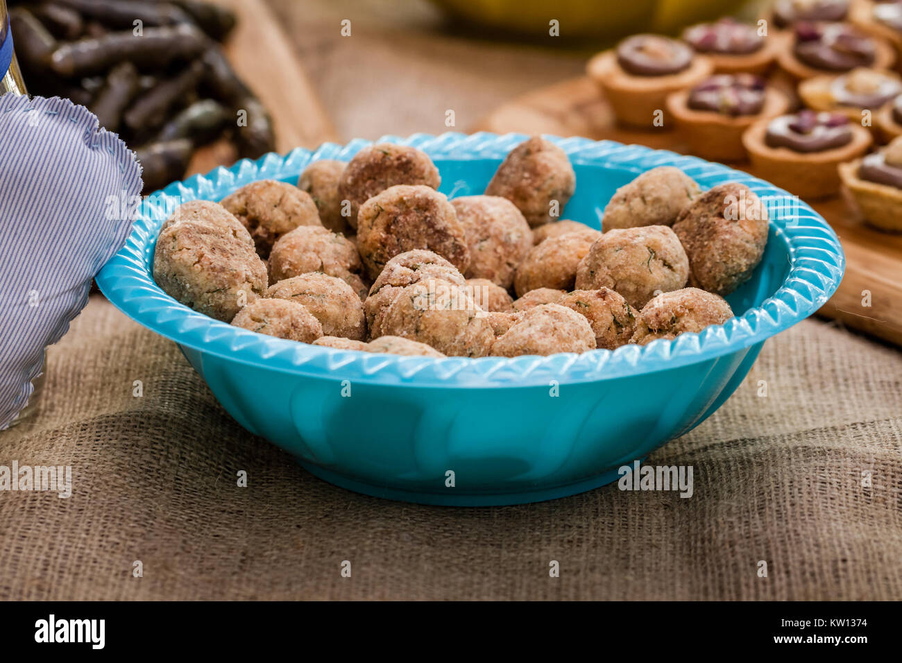 Cookie balls in a blue bowl on a party buffet counter Stock Photo - Alamy