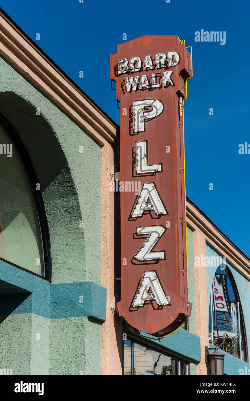 An old neon Board Walk Plaza sign attached to a stucco building near ...