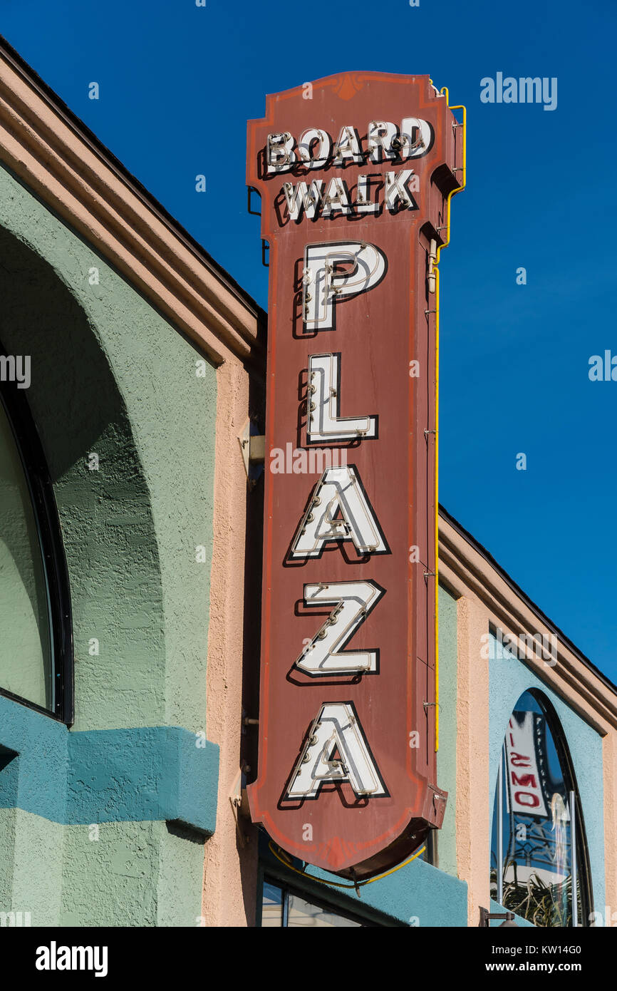 An old neon Board Walk Plaza sign attached to a stucco building near ...