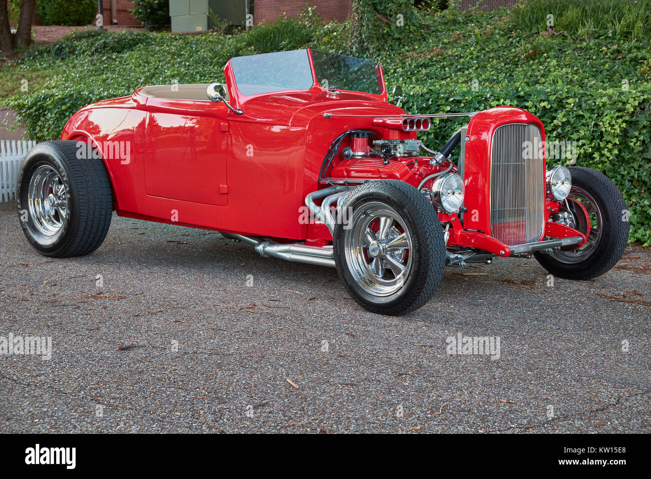 1932 red Ford hot rod roadster on side view display showing open engine ...