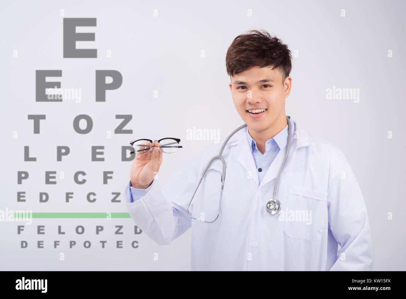 Optometrist looking at camera in medical office Stock Photo - Alamy