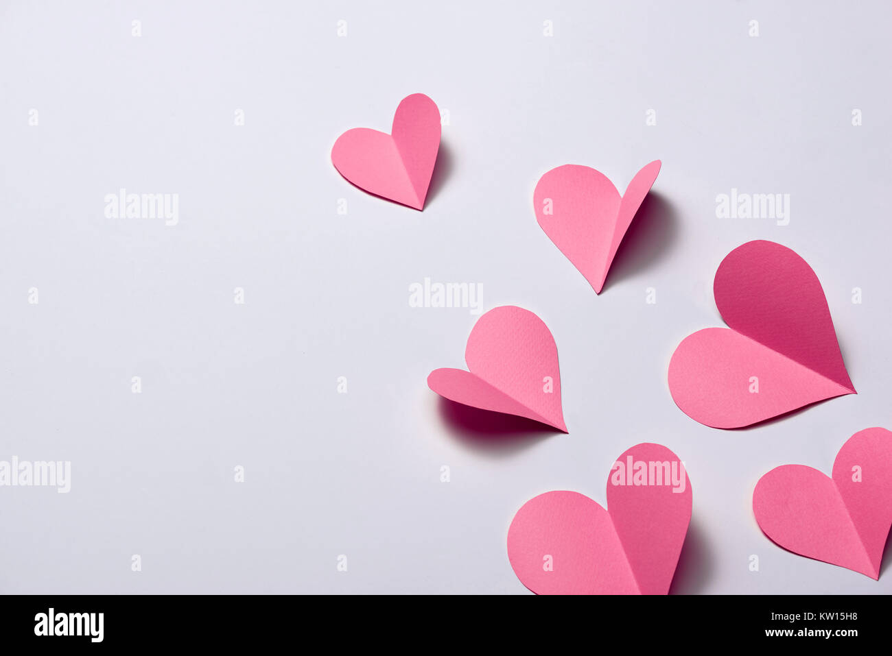 Beautiful pink paper hearts on white paper background Stock Photo - Alamy