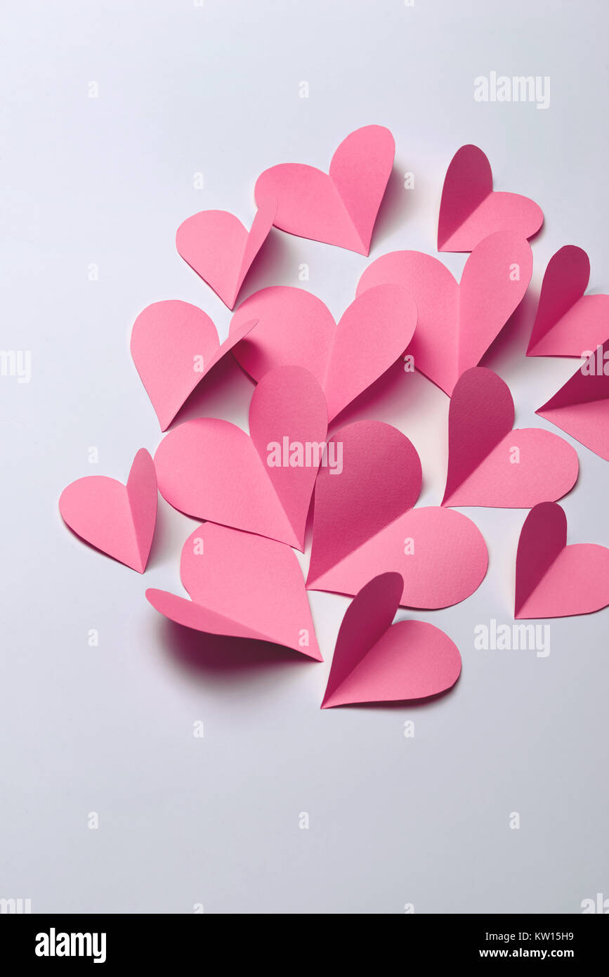 Beautiful pink paper hearts on white paper background Stock Photo - Alamy