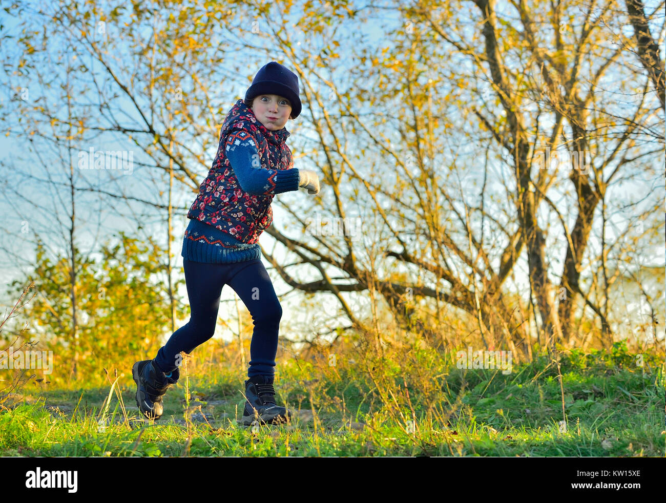 Laughing Happy little girl running in sunlight on autumn meadow Stock ...