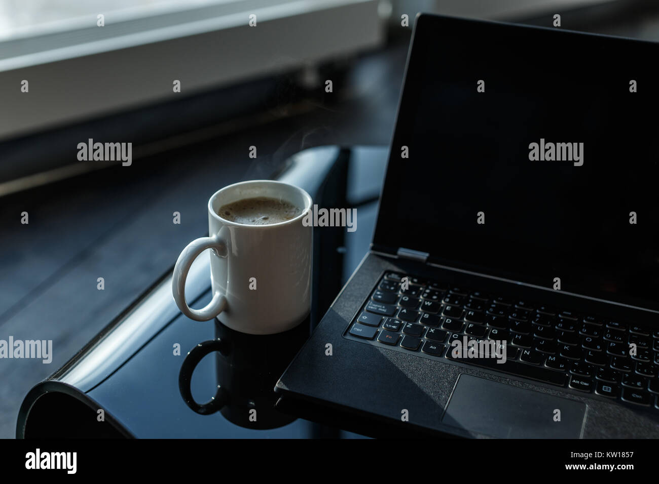 Cup of coffee and laptop Stock Photo - Alamy