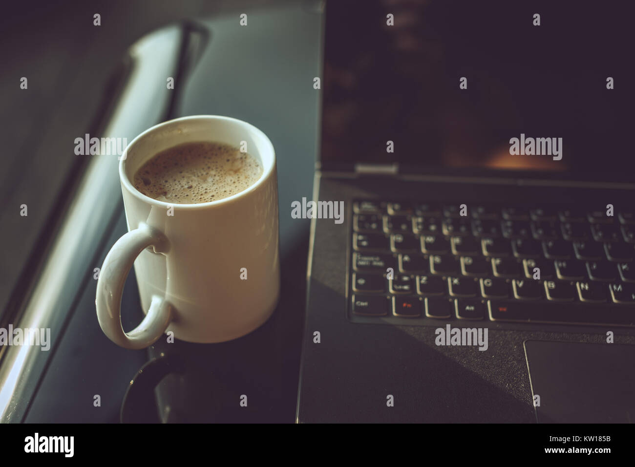 Cup of coffee and laptop Stock Photo - Alamy