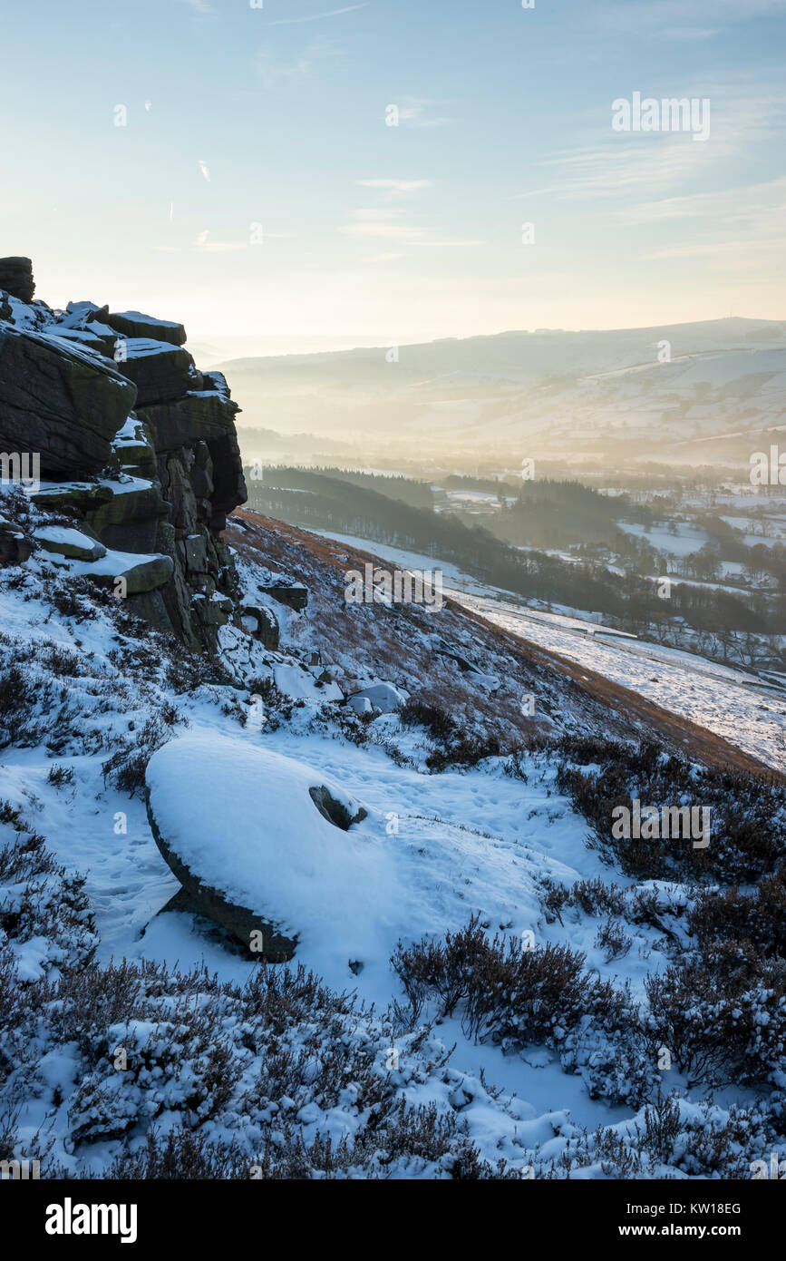 Dawn at Bamford edge in the Peak District on a cold winter morning. An ...