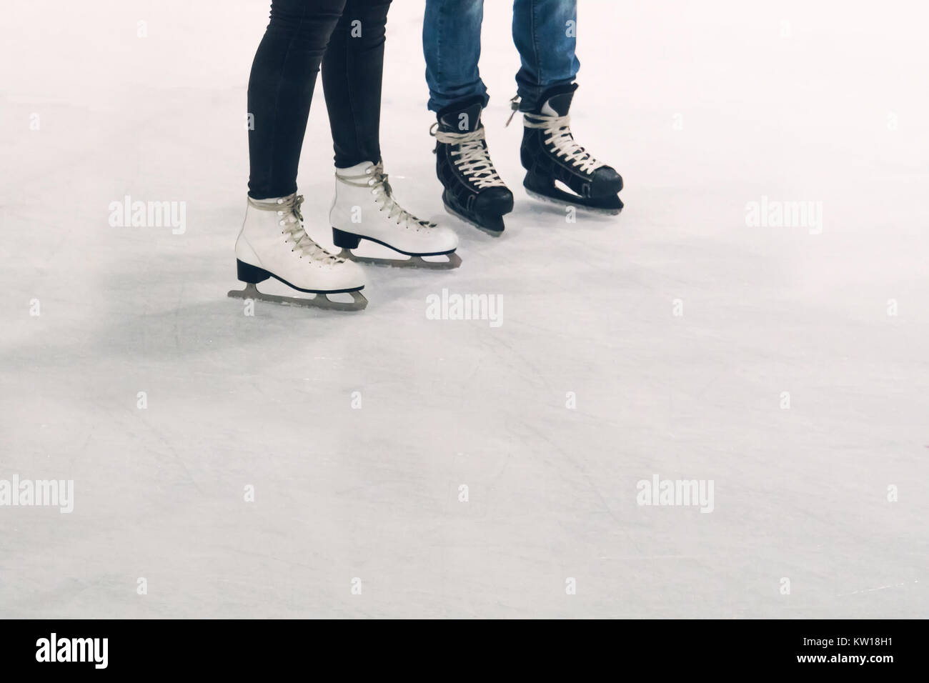 Woman and man ice skating. winter outdoors on ice rink. ice and legs ...