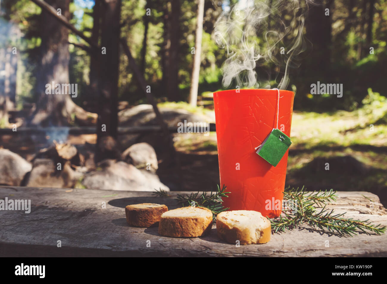 Tea bag in orange plastic Cup. Tourist Hiking romance. Breakfast in the ...