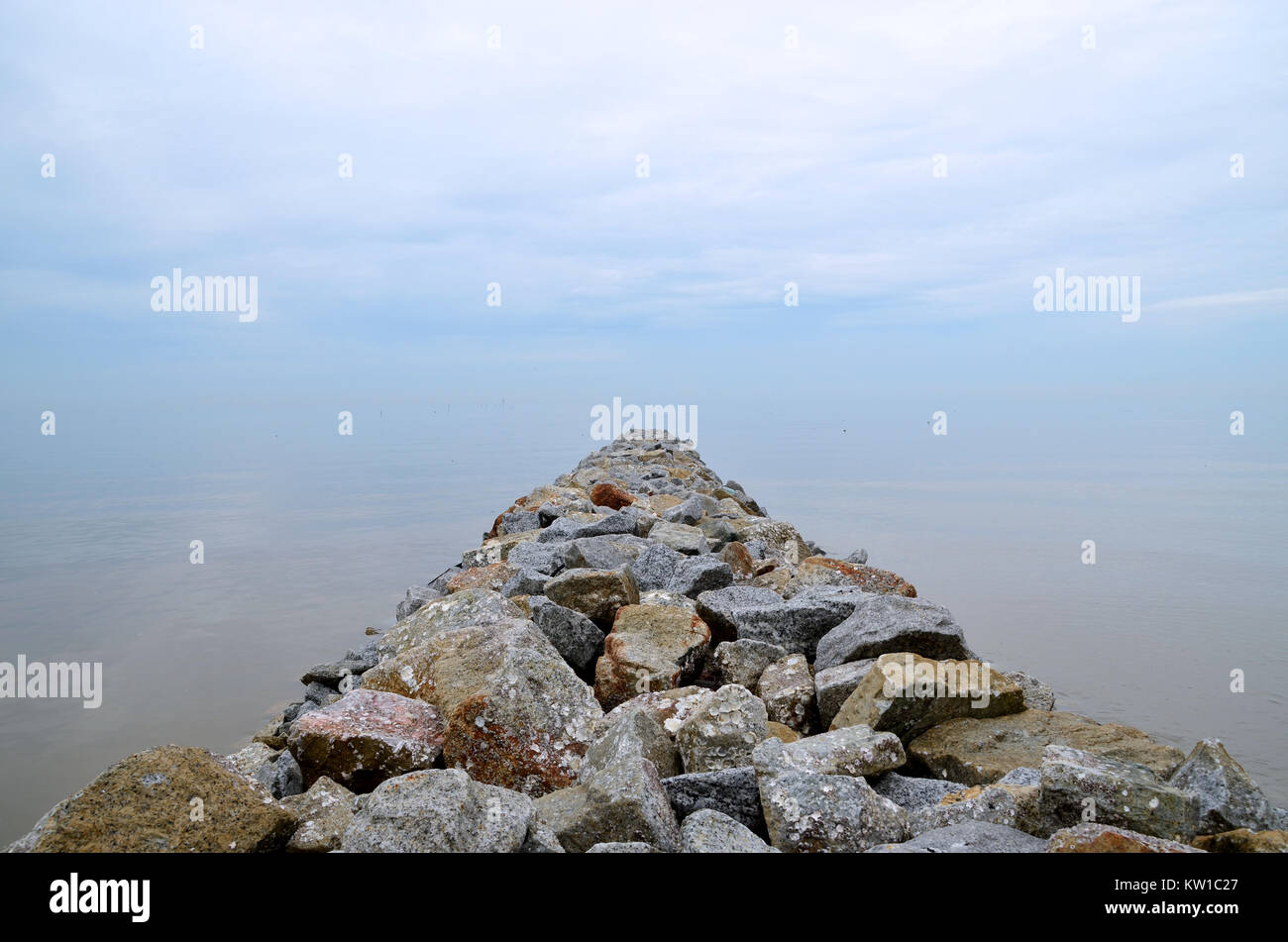 stacked rocks at the beach. wave breaker Stock Photo - Alamy