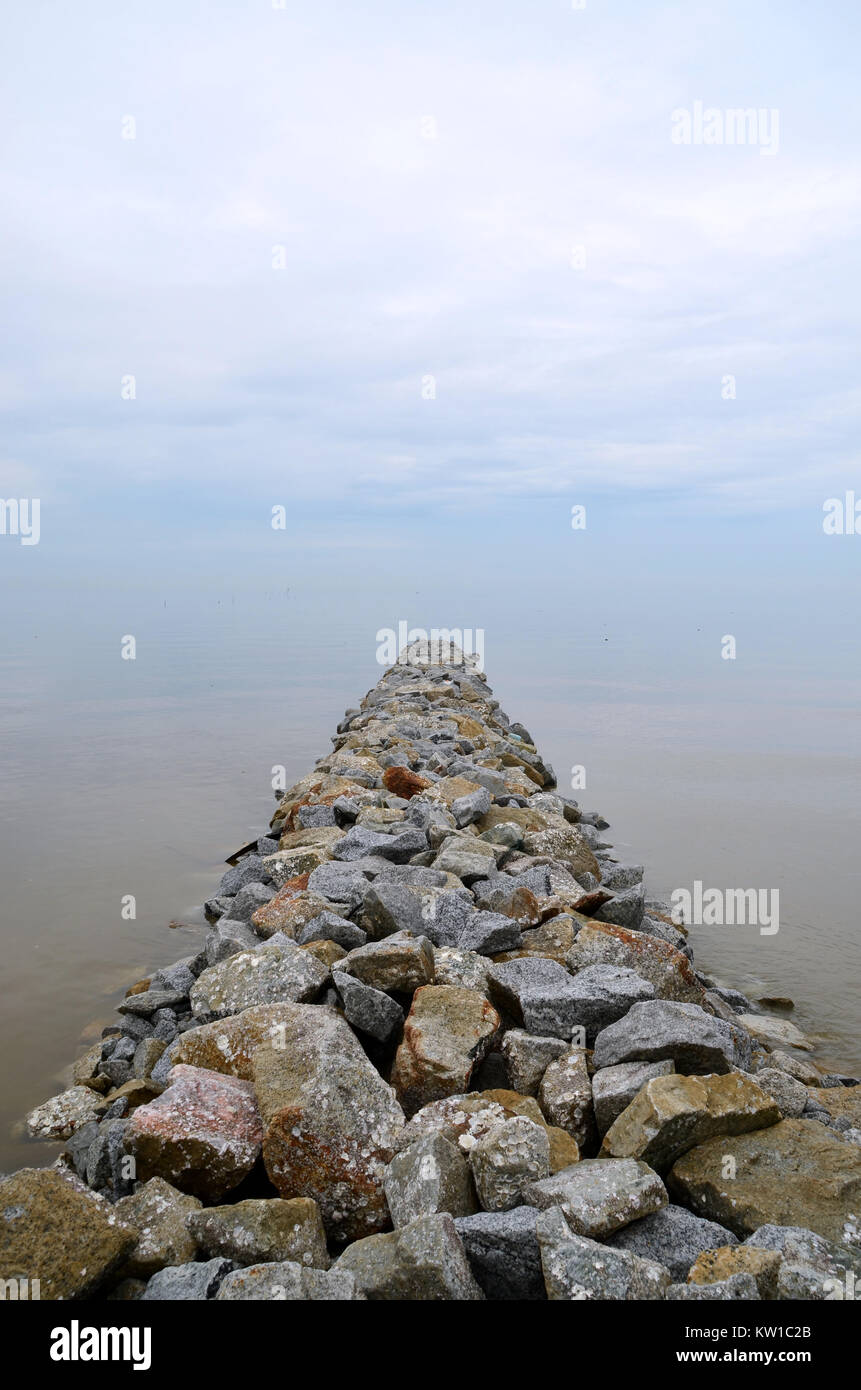 stacked rocks at the beach. wave breaker Stock Photo - Alamy