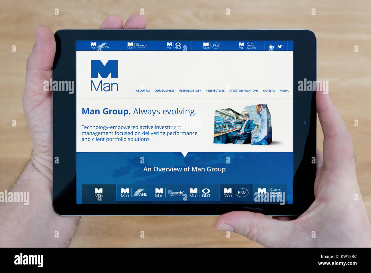 A man looks at the Man Group PLC website on his iPad tablet device ...