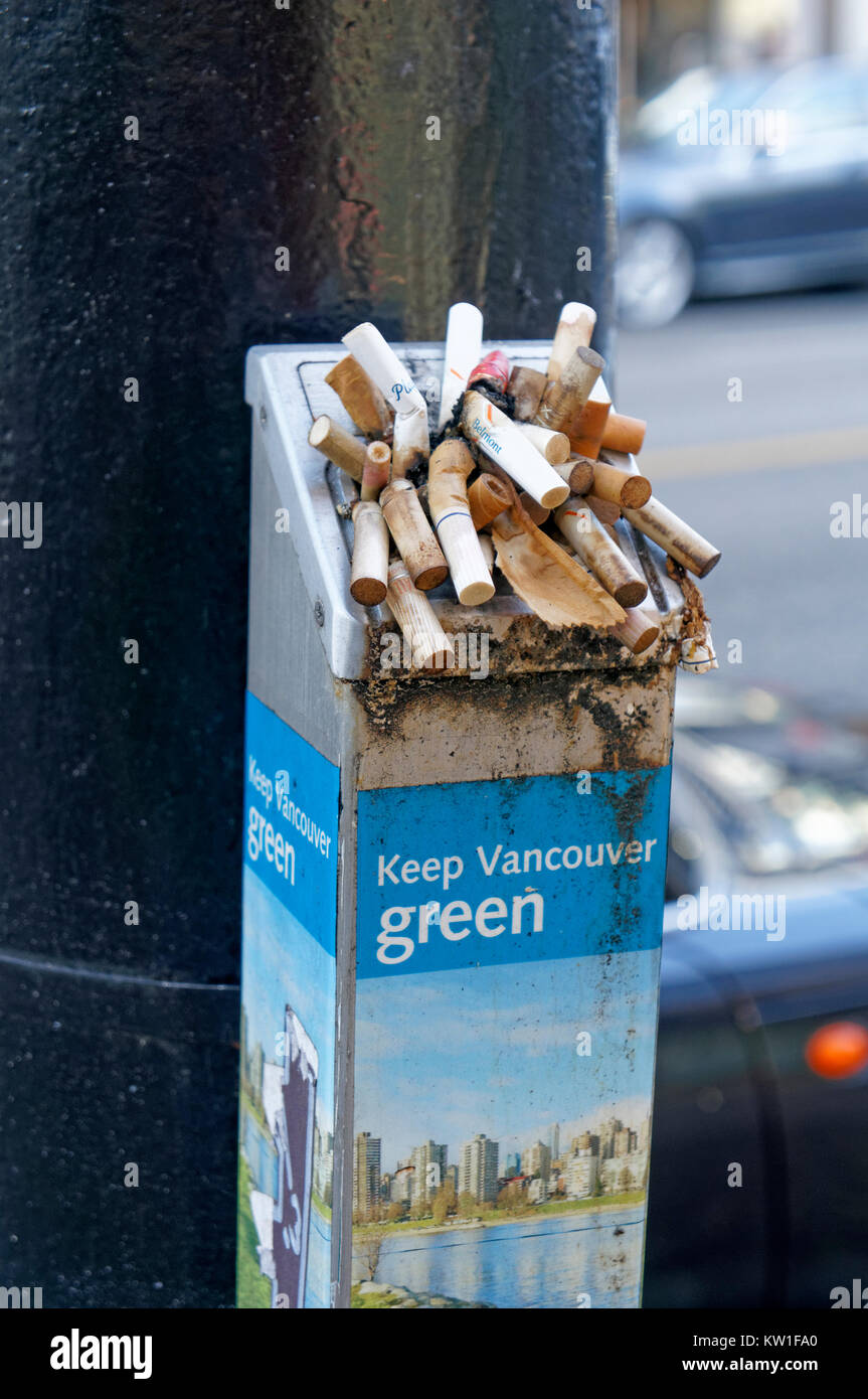 Cigarette butt recycling bin stuffed with cigarettes in downtown ...