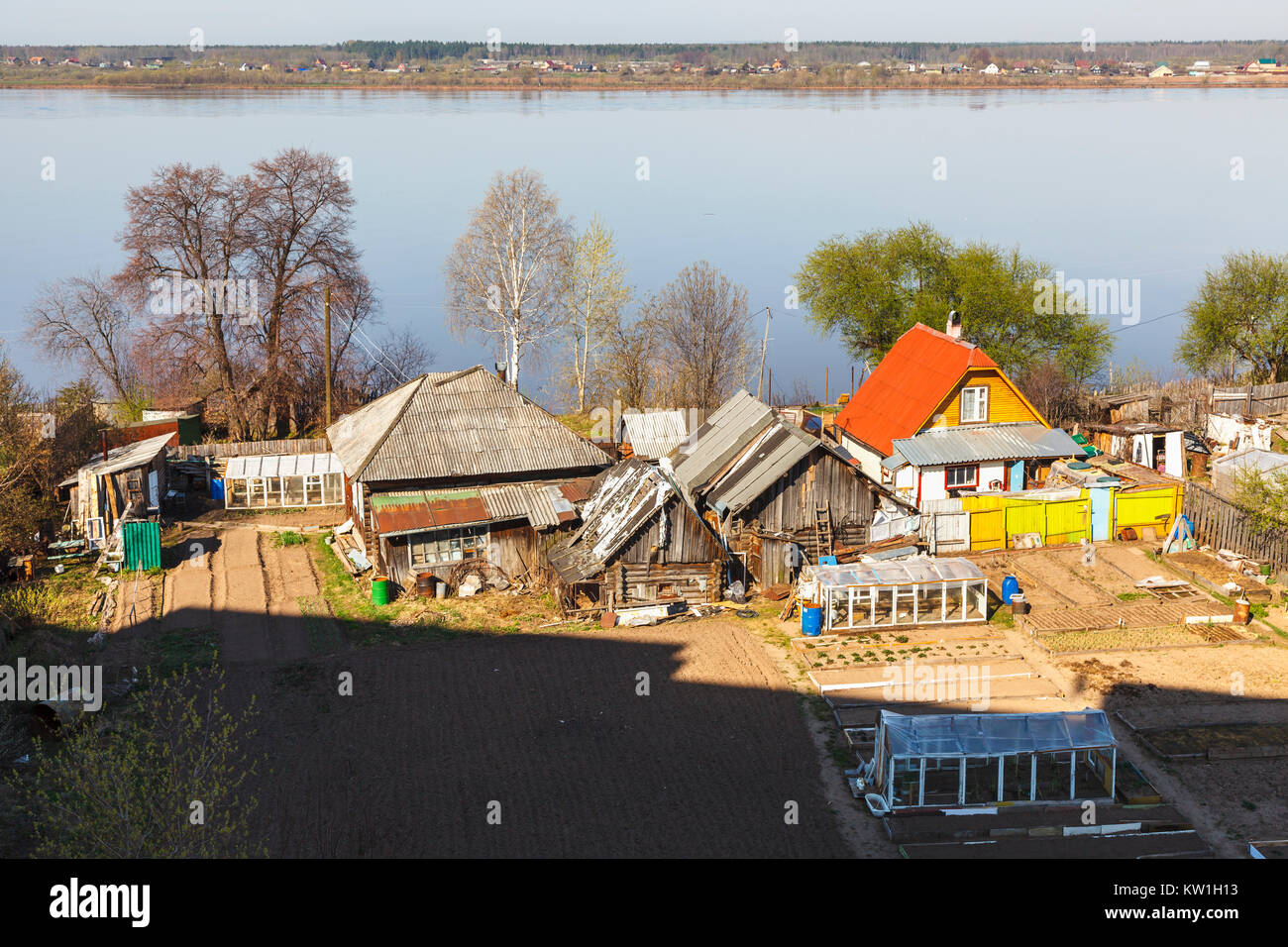Dilapidated houses and smallholdings on the banks of the Kama River ...
