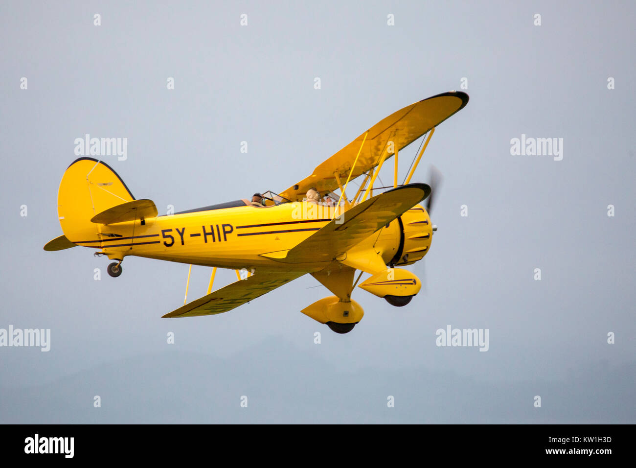 A 1930's Waco biplane flying at dawn over Laikipia, very close view ...