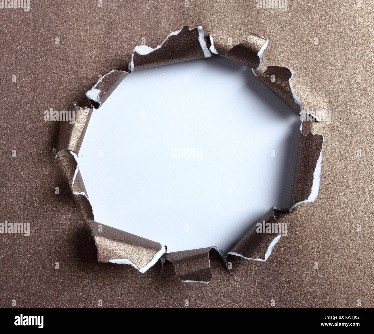 Hole ripped in brown paper Stock Photo - Alamy