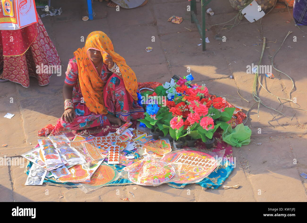 Indian woman sells stickers and flowers at Sardar street market in ...