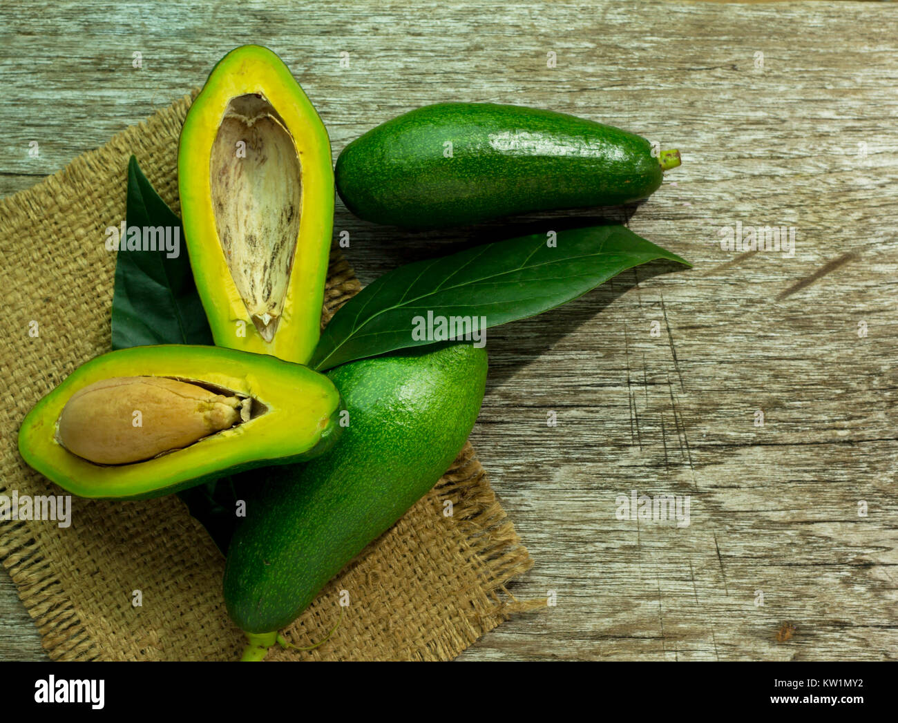 food background with fresh organic avocado on old wooden table, top ...
