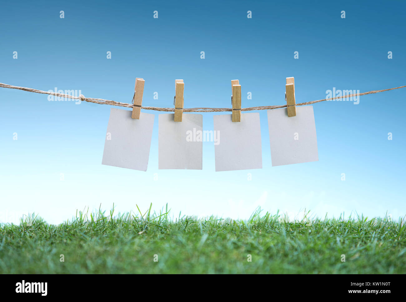 Hanging blank paper on clothesline in field Stock Photo - Alamy