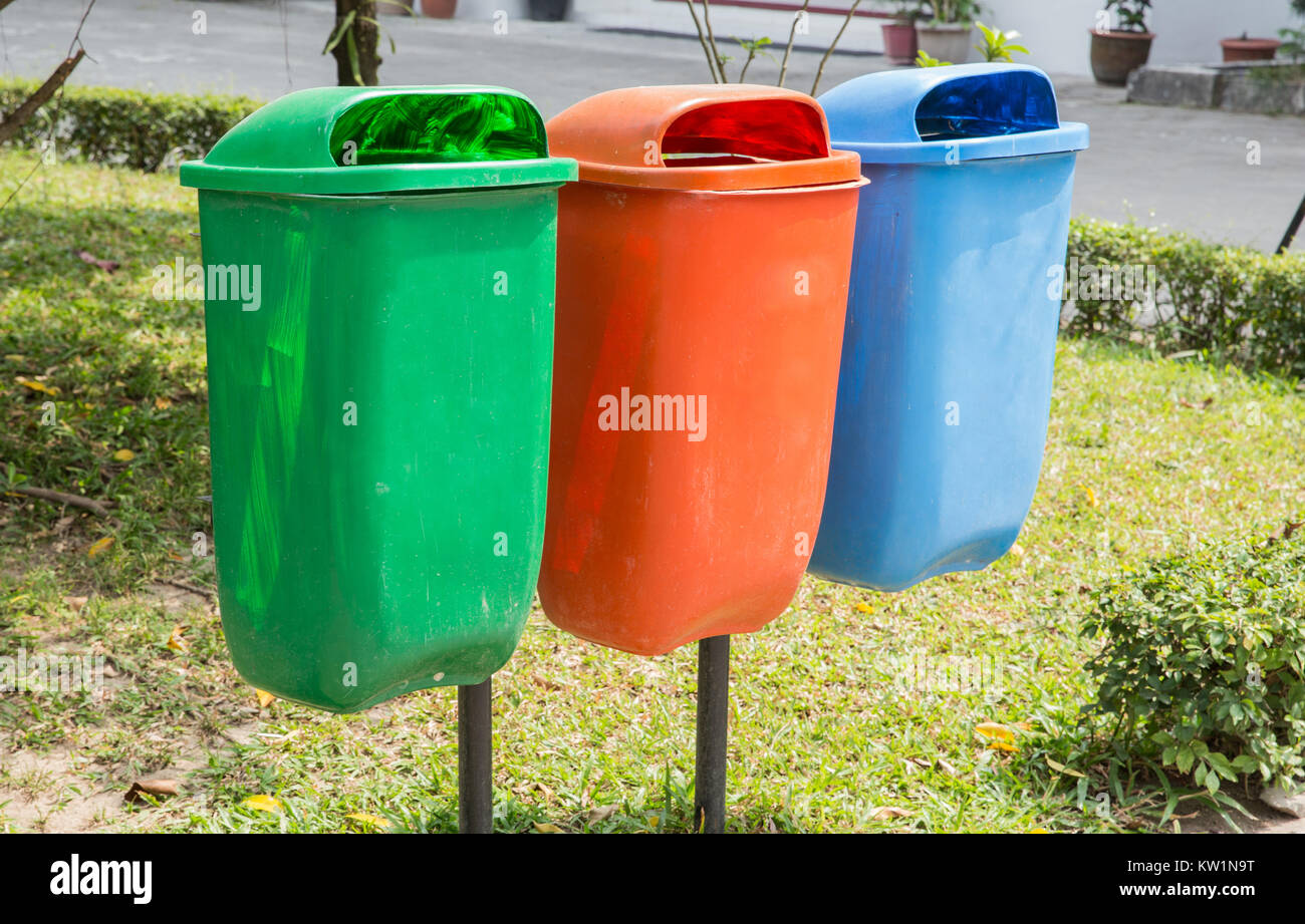 Three trash bin in different colors on a park Stock Photo - Alamy