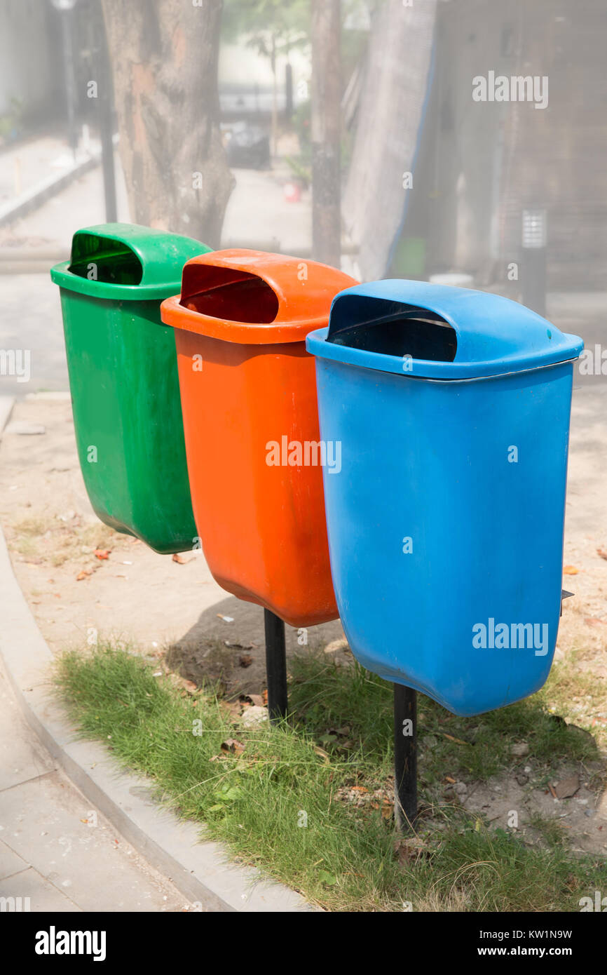 Three trash bin in different colors on a park Stock Photo - Alamy