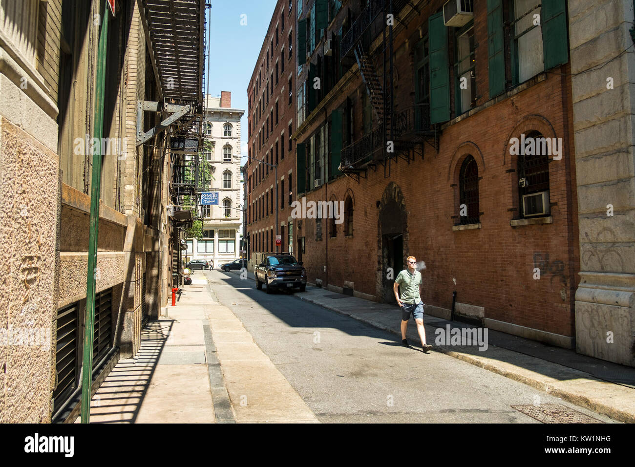 Man in alley smoking cigarette hi-res stock photography and images - Alamy