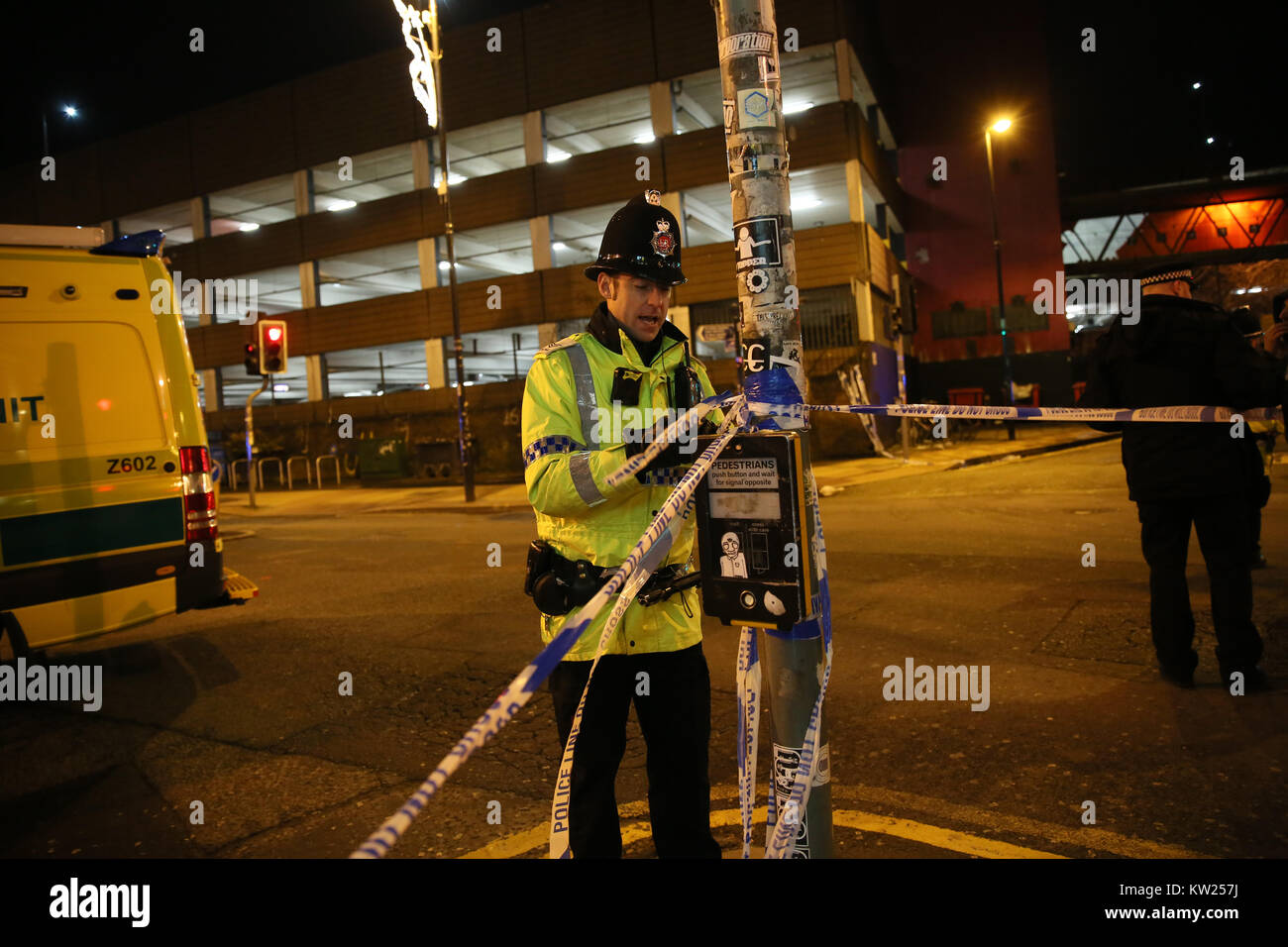 Manchester, UK. 30th December, 2017. A Police officer tapes access to ...