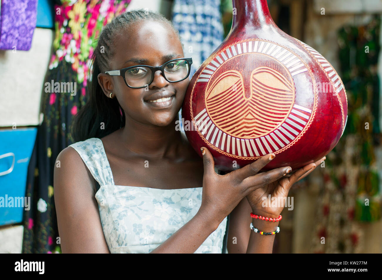 Craft stall proprietor holding decorated gourd, Handicraft Centre ...