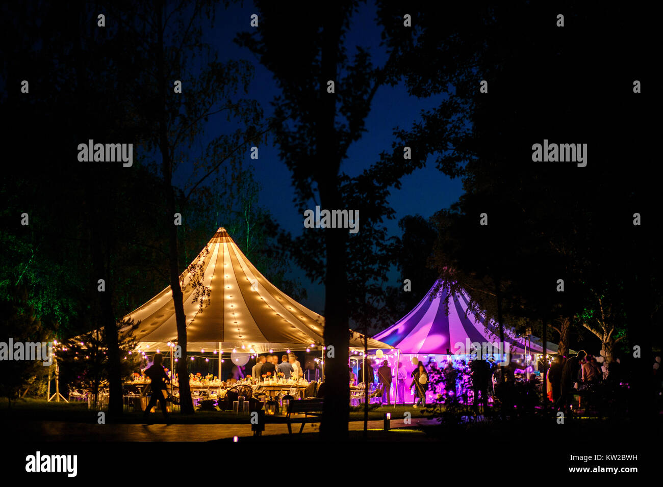 Colorful wedding tents at night. Wedding day Stock Photo - Alamy
