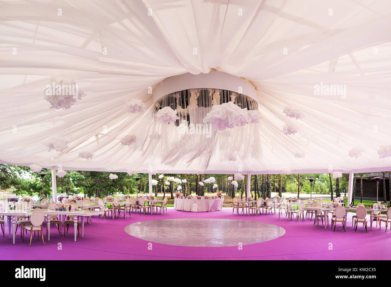 Banquet hall for a wedding with a white dome. Tables sets for wedding ...