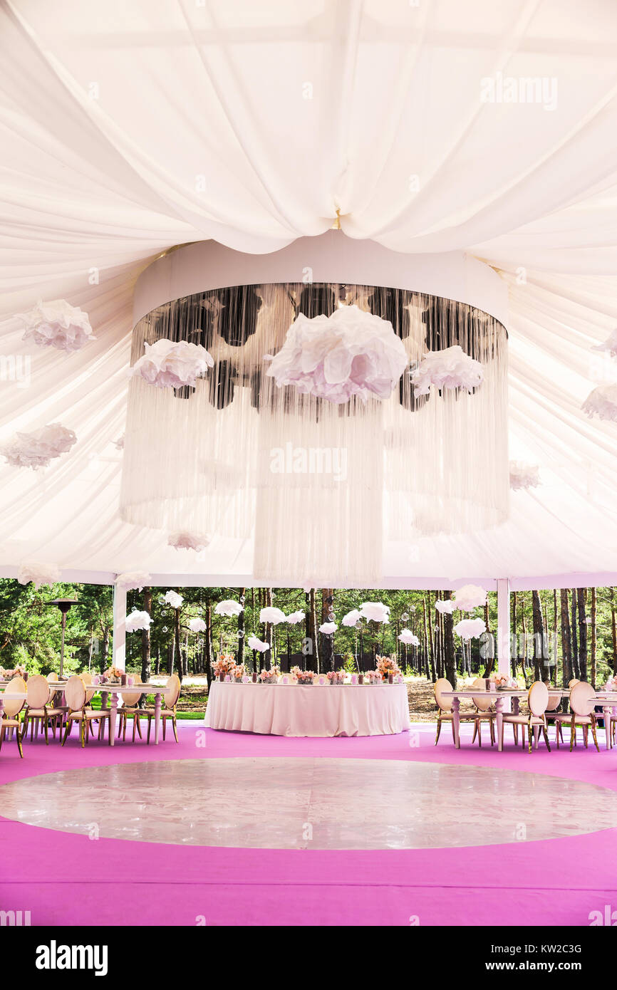 Banquet hall for a wedding with a white dome. Tables sets for wedding ...