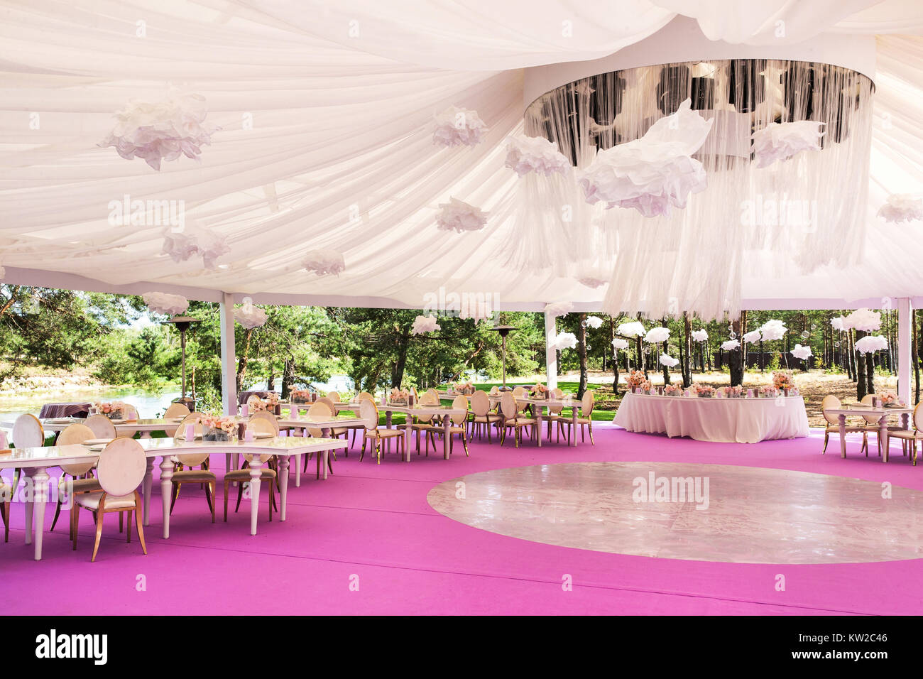 Banquet hall for a wedding with a white dome. Tables sets for wedding ...