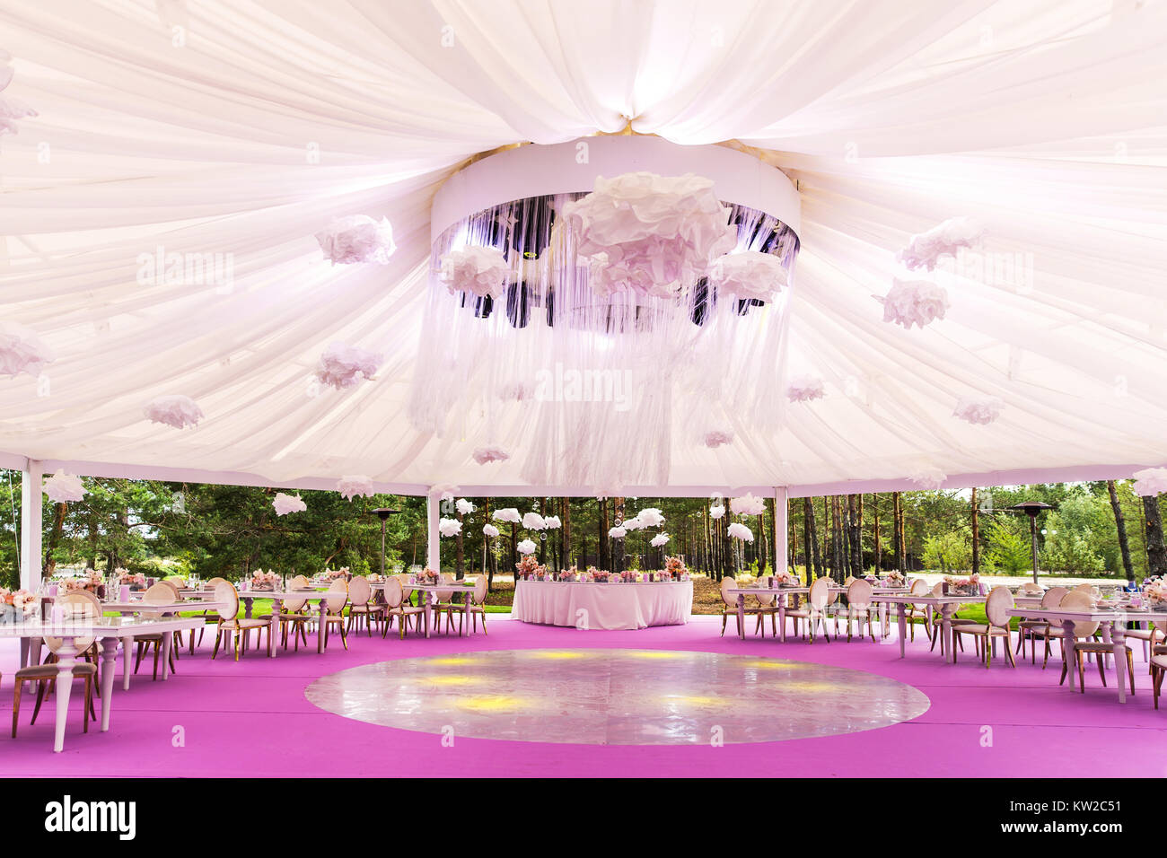 Banquet hall for a wedding with a white dome. Tables sets for wedding ...