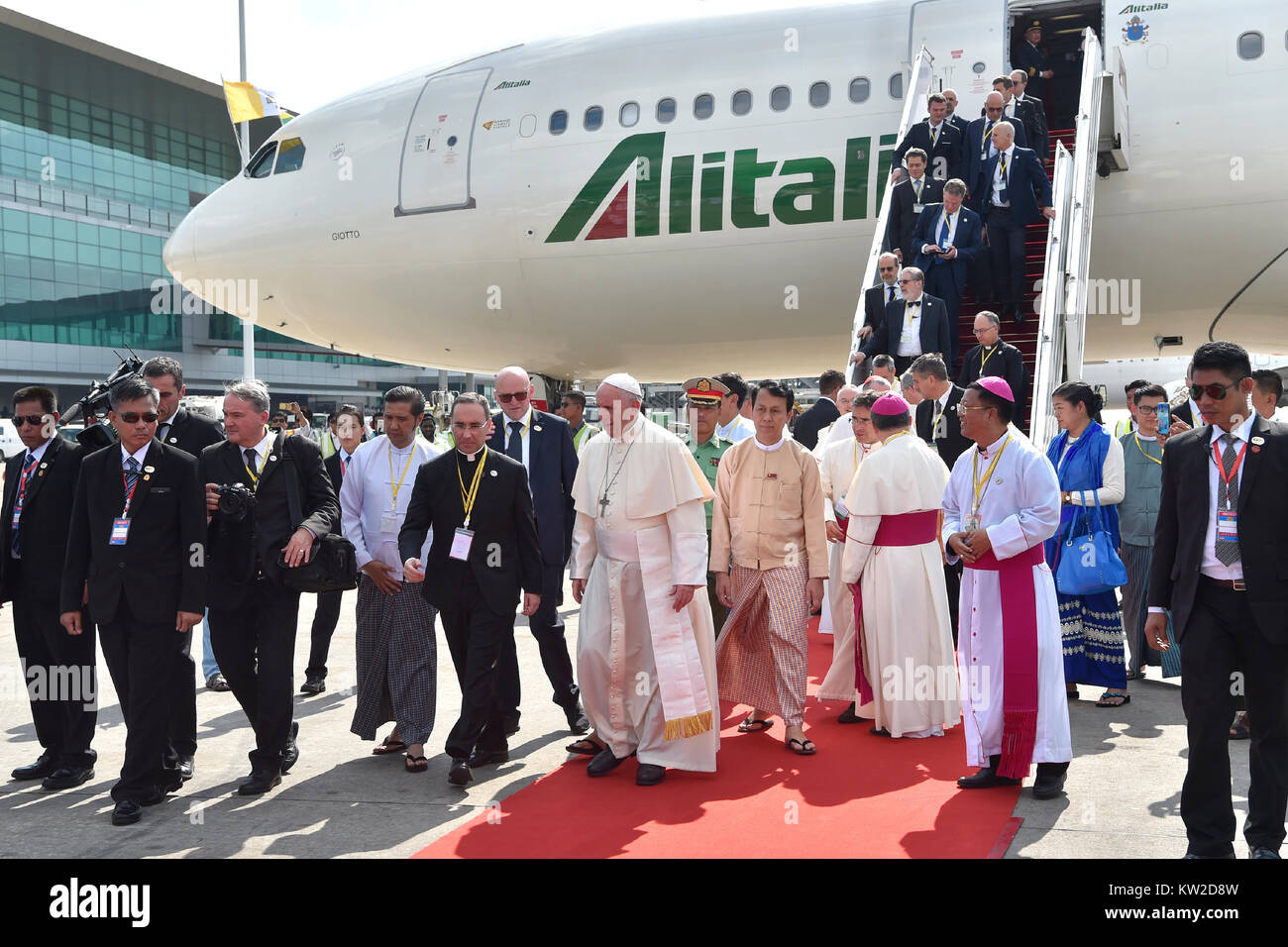 Pope Francis is welcomed upon his arrival at the airport in Yangon ...