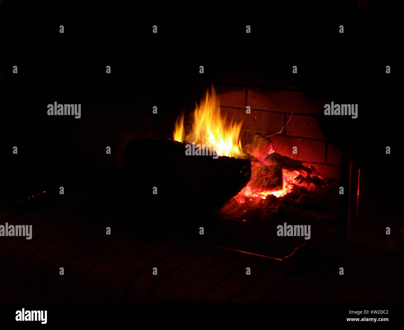 Fireplace with open fire Stock Photo - Alamy