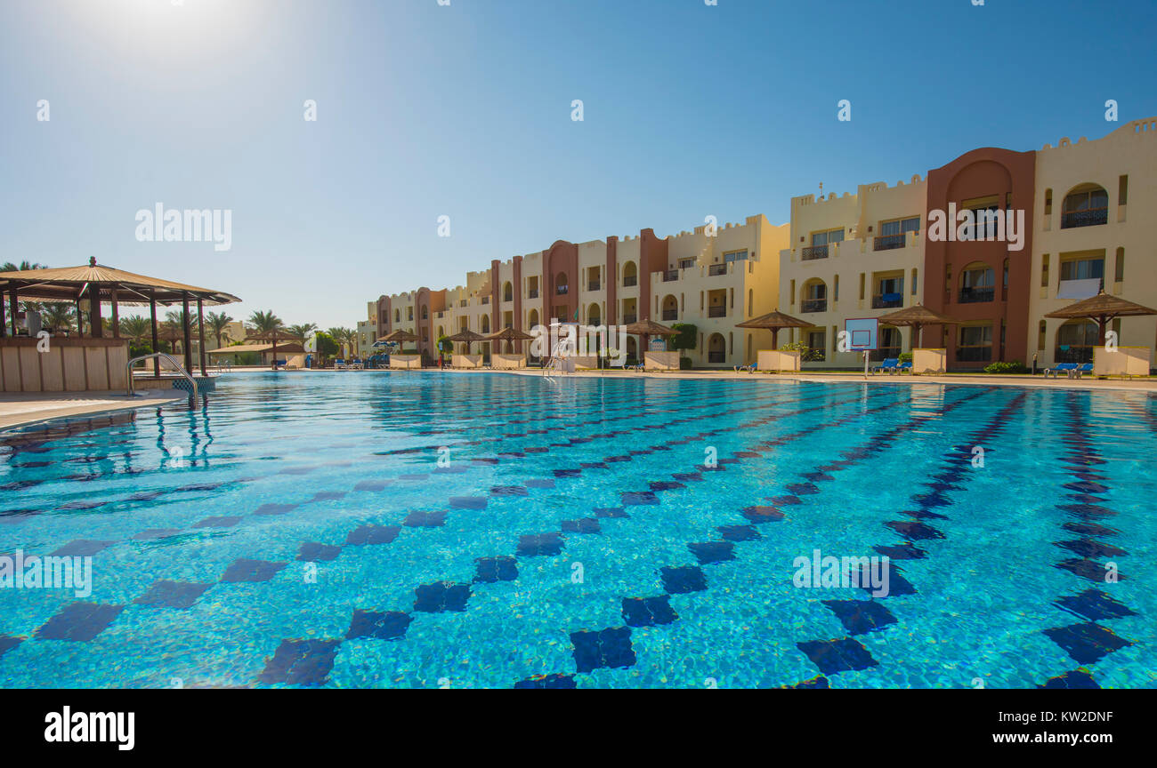 Large swimming pool with buildings at a luxury tropical hotel resort ...