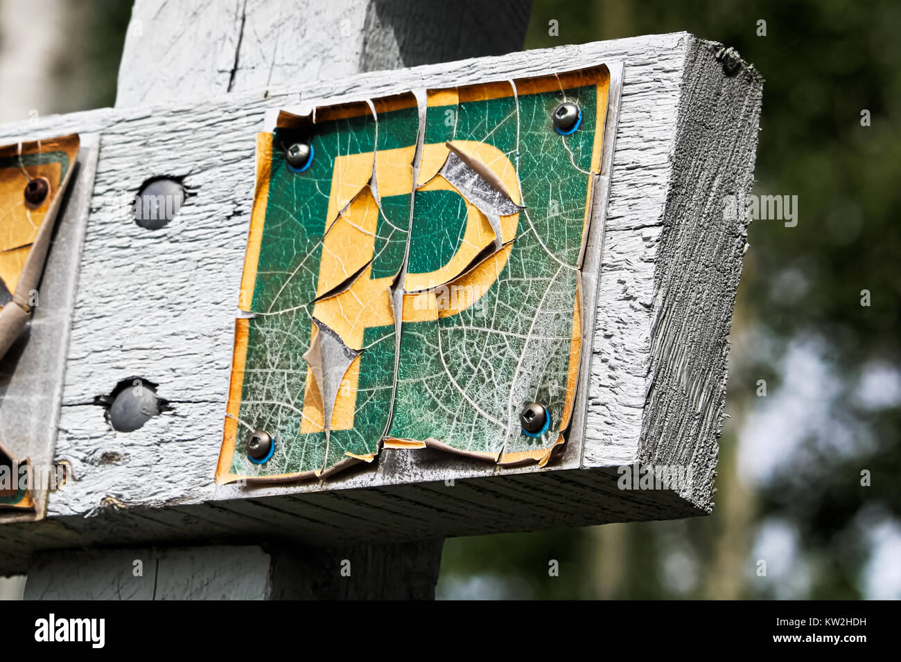 A faded peeling parking sign on wood Stock Photo - Alamy