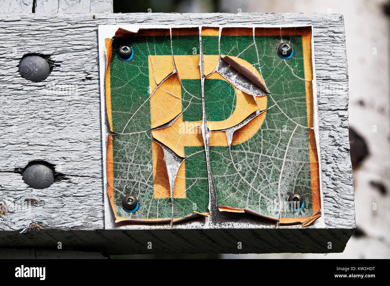 A faded peeling parking sign on wood Stock Photo - Alamy