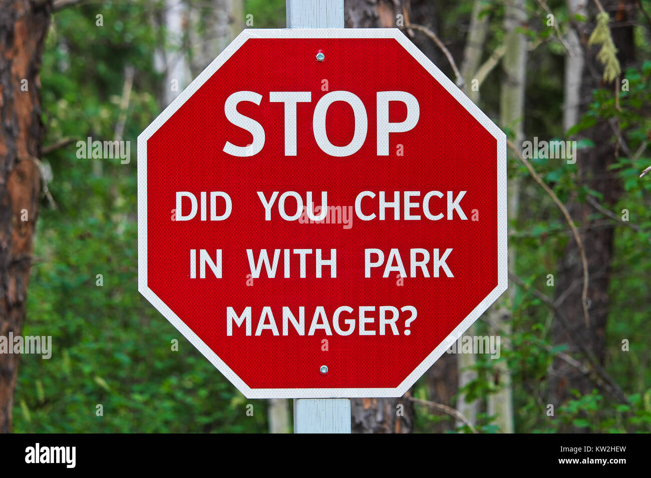 A stop, did you check with the park manager sign Stock Photo - Alamy