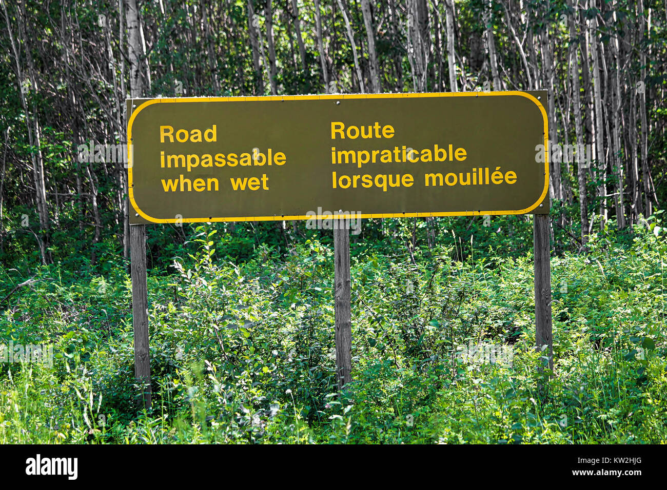 A bilingual road impassable when wet sign Stock Photo - Alamy