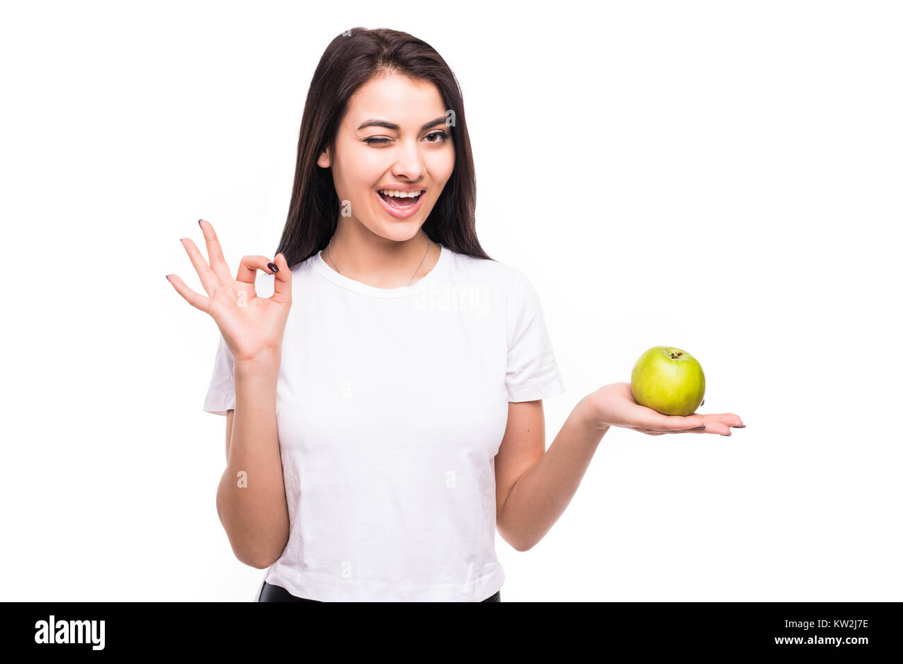 healthy woman giving ok hand gesture with green apple Stock Photo - Alamy