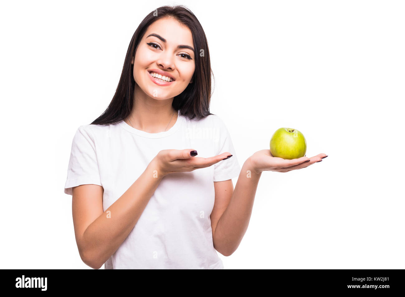 Close up of a cheery happy girl pointing at an apple on her palm ...