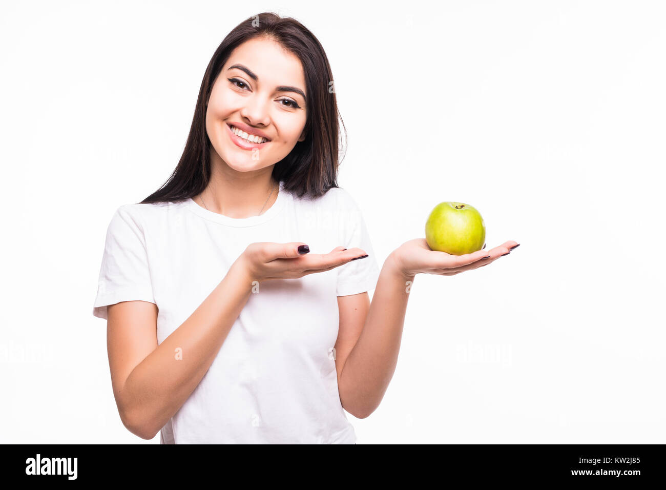 Close up of a cheery happy girl pointing at an apple on her palm ...