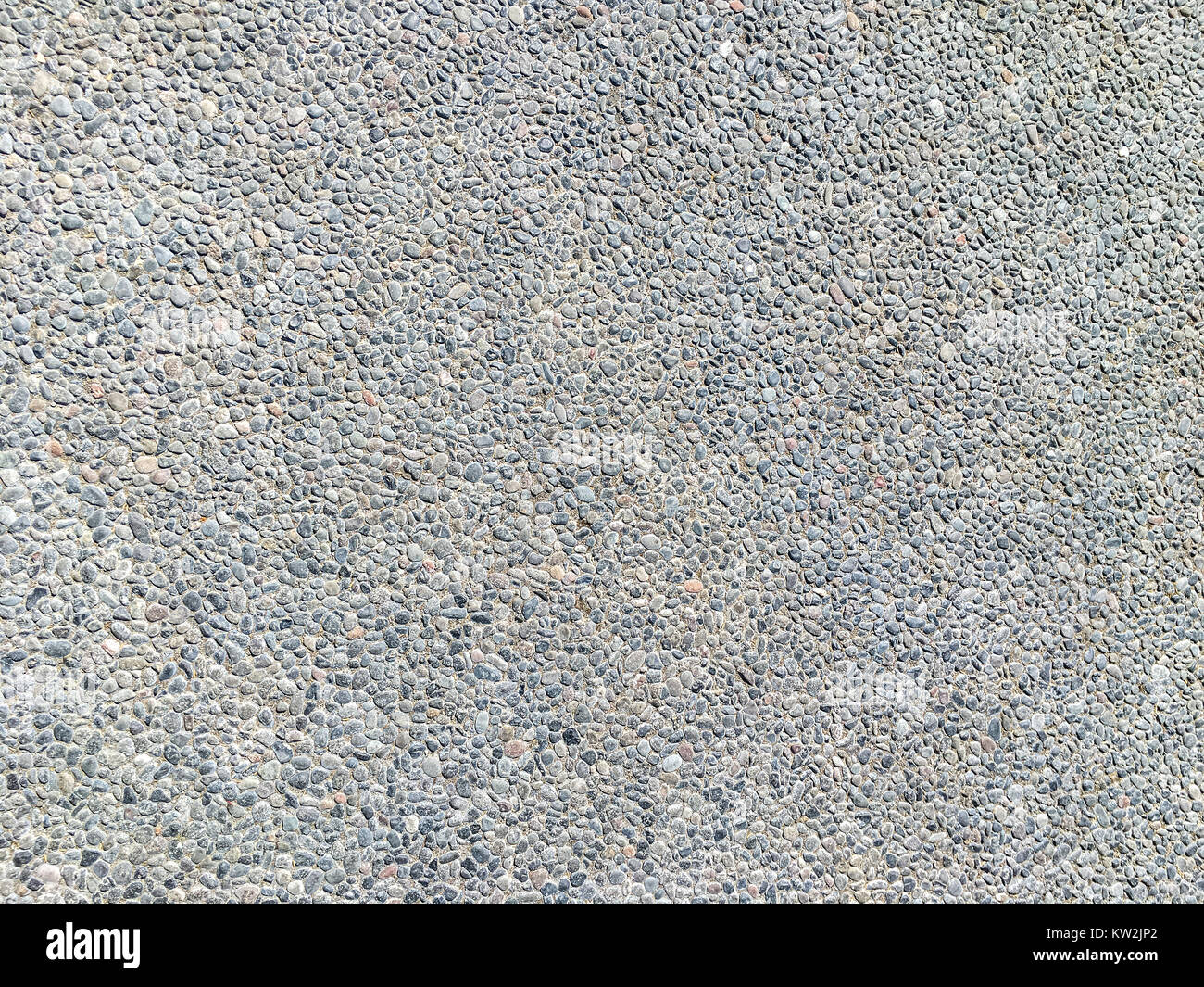 Stone road from small gravel. Old street cobbles on the sidewalk Stock ...