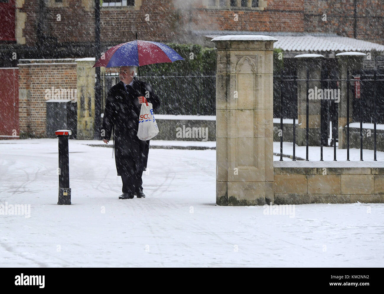 A man walks through the snow in York after Britain saw one of the ...