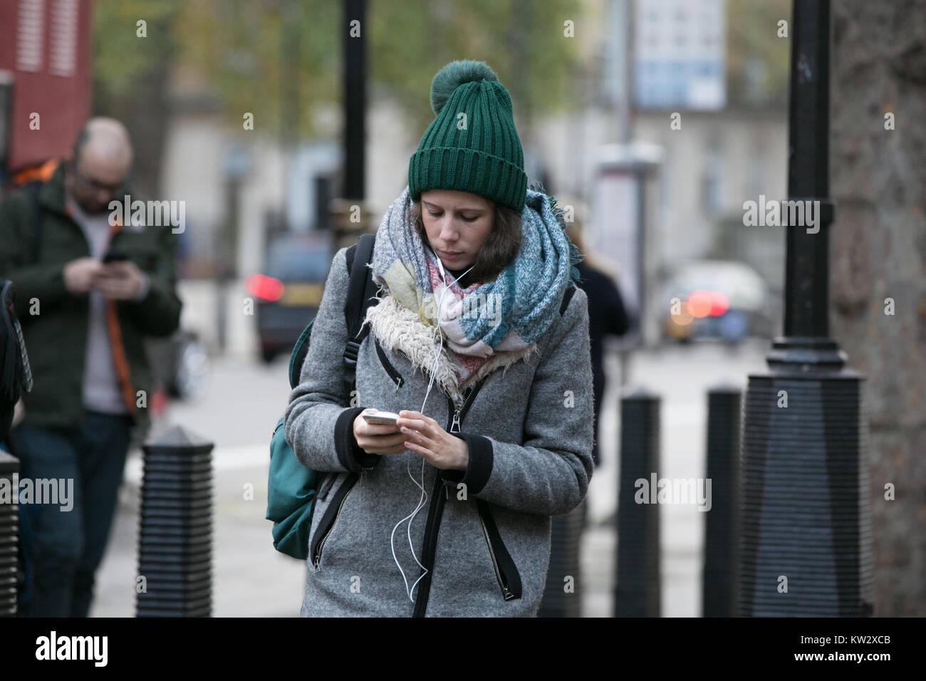 Commuters in Westminster on a cold and wet morning in London. Featuring ...