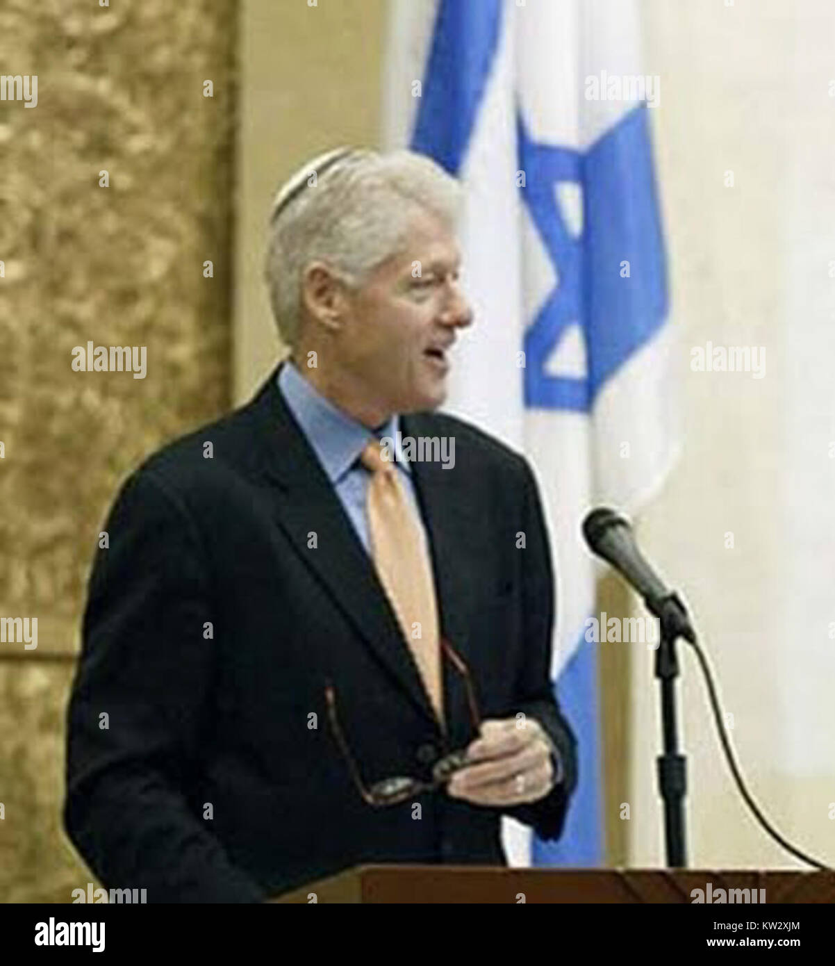 This image depicts Bill Clinton wearing a yarmulke at a synagogue ...