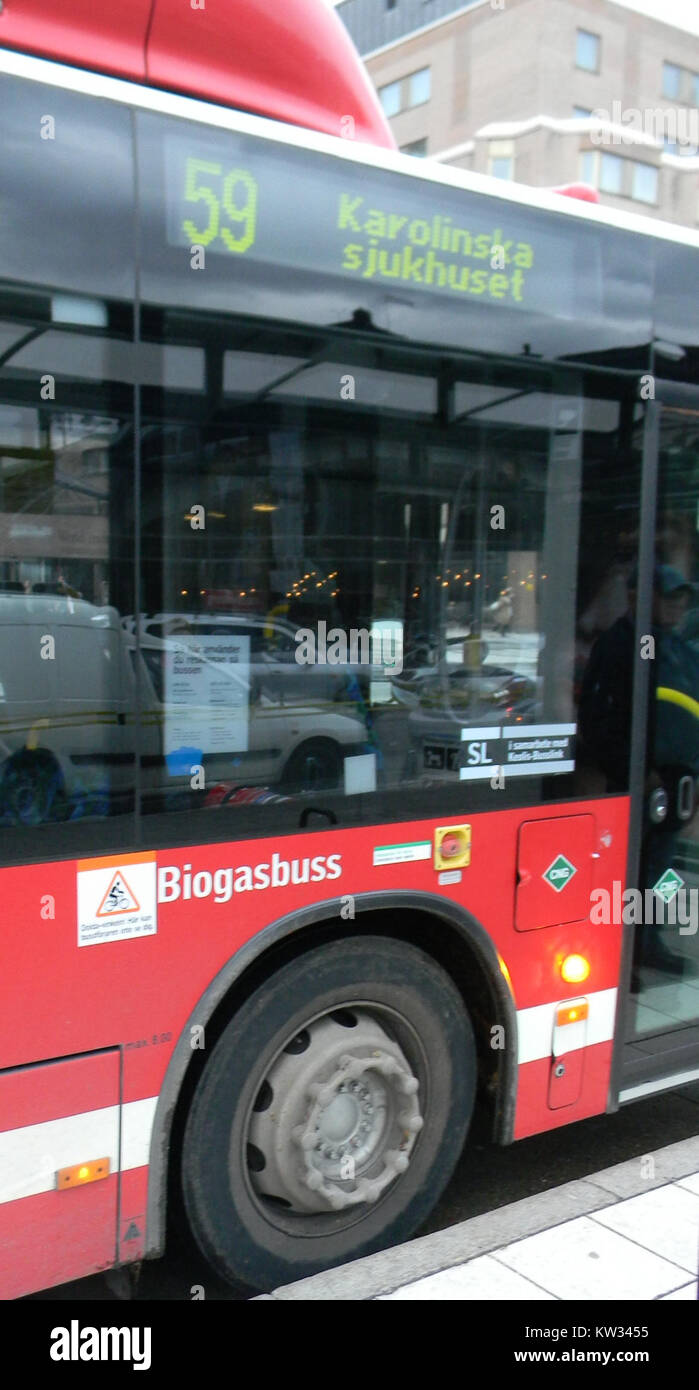This image features a close-up detail of a biogas bus, an ...